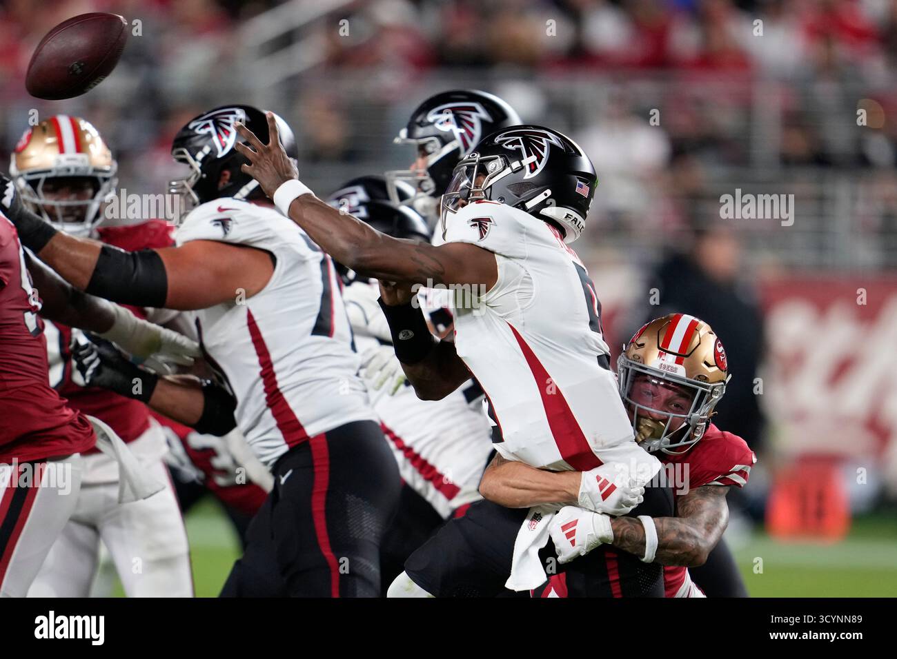 Atlanta Falcons quarterback Michael Penix Jr. (9) passes under pressure from San Francisco 49ers ...