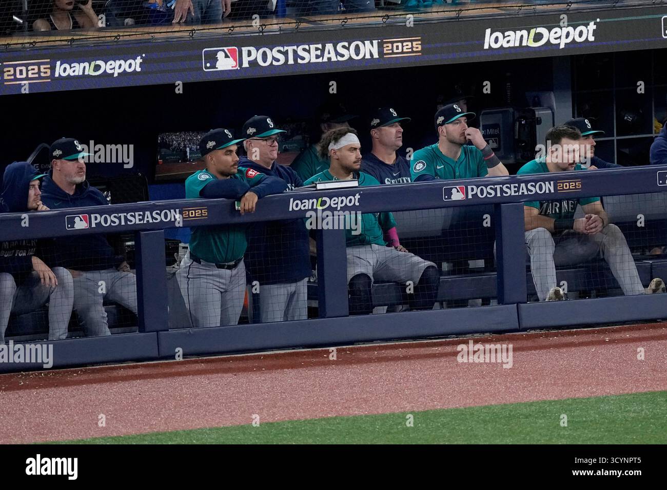 Seattle Mariners players watch from the dugout during the ninth inning ...