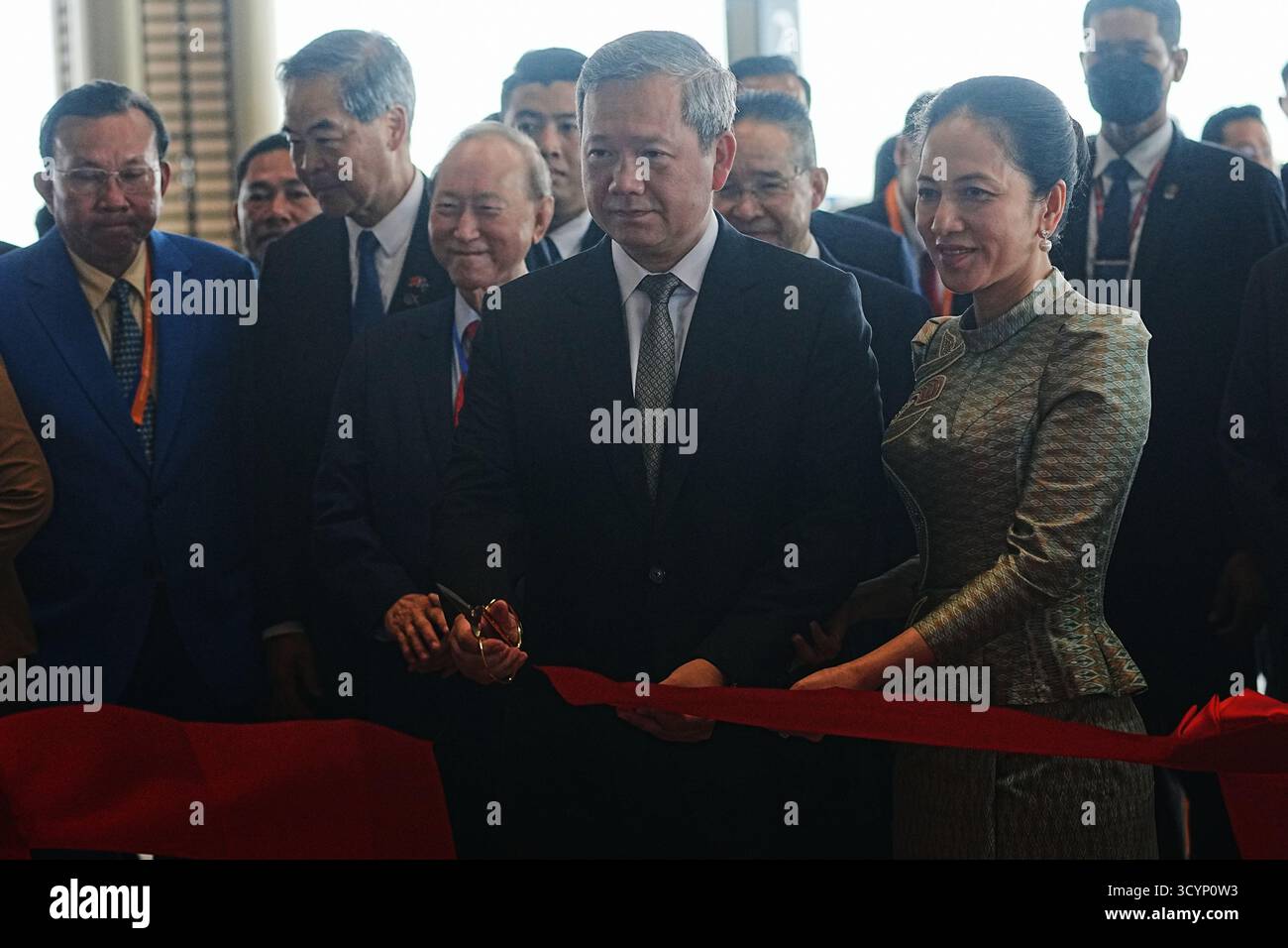 Cambodian Prime Minister Hun Manet, center, cuts the ribbon with his ...