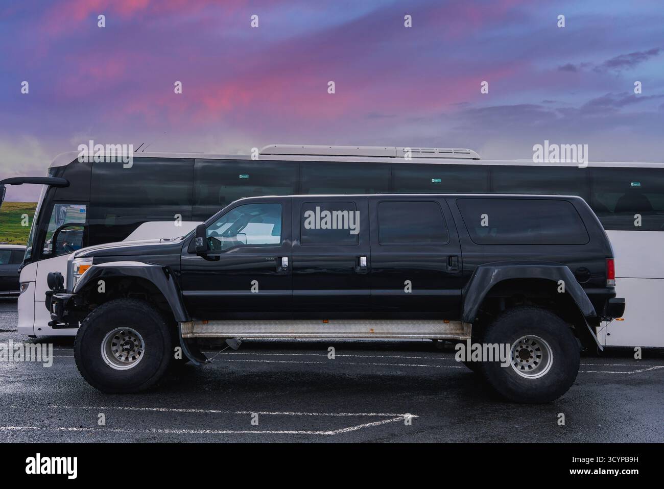 Black super jeep and tour coach at twilight, Iceland parking area Stock ...