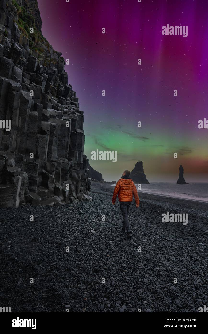 Aurora over Reynisfjara basalt columns and Reynisdrangar sea stacks ...