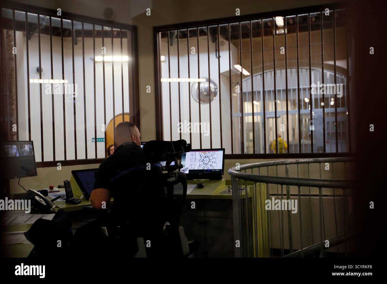 FILE - A prison service guard checks the security screens at the ...