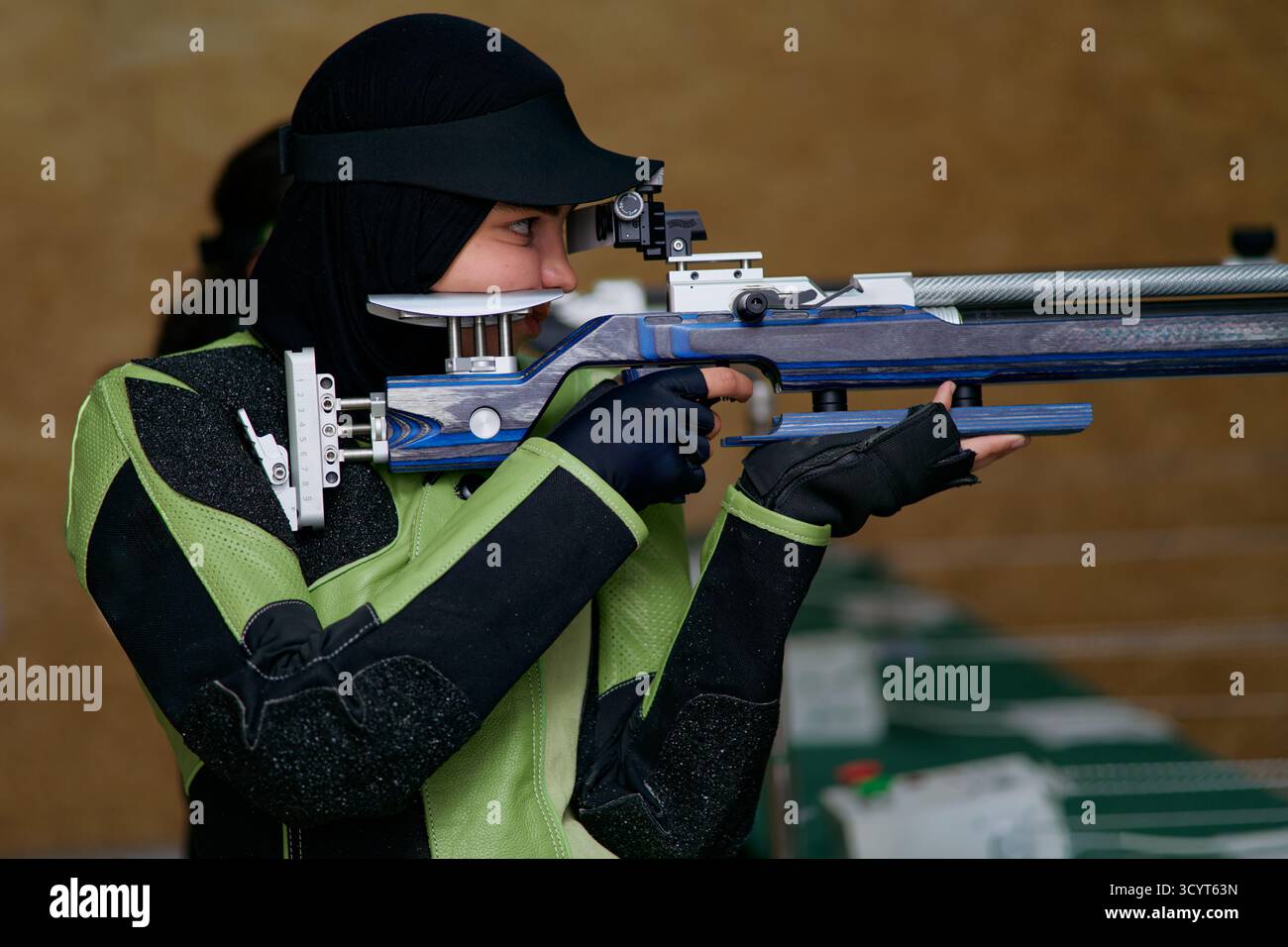Female athlete wearing professional shooting uniform and hijab ...