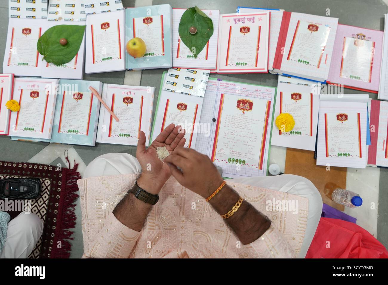 An Indian trader performs rituals during Chopda Pujan, a prayer ...