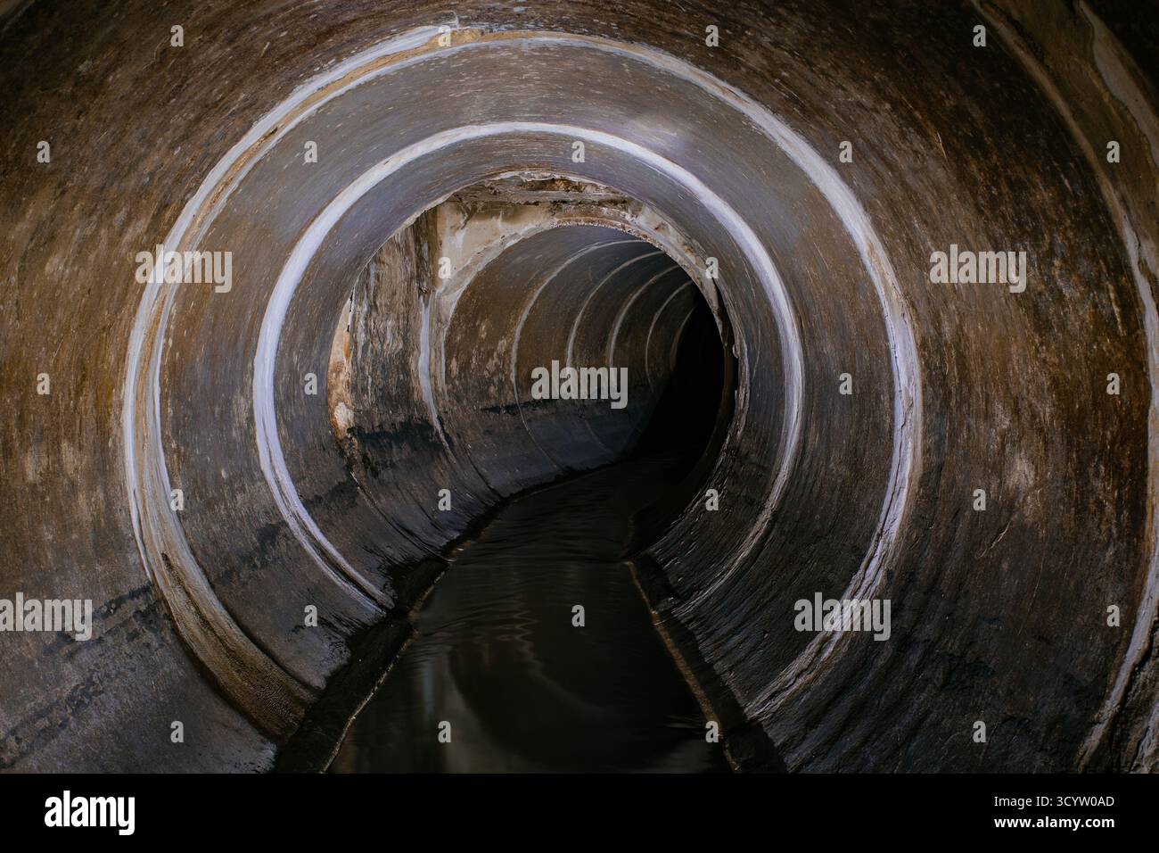 Inside underground urban sewer system. Dirty sewage flowing in round ...