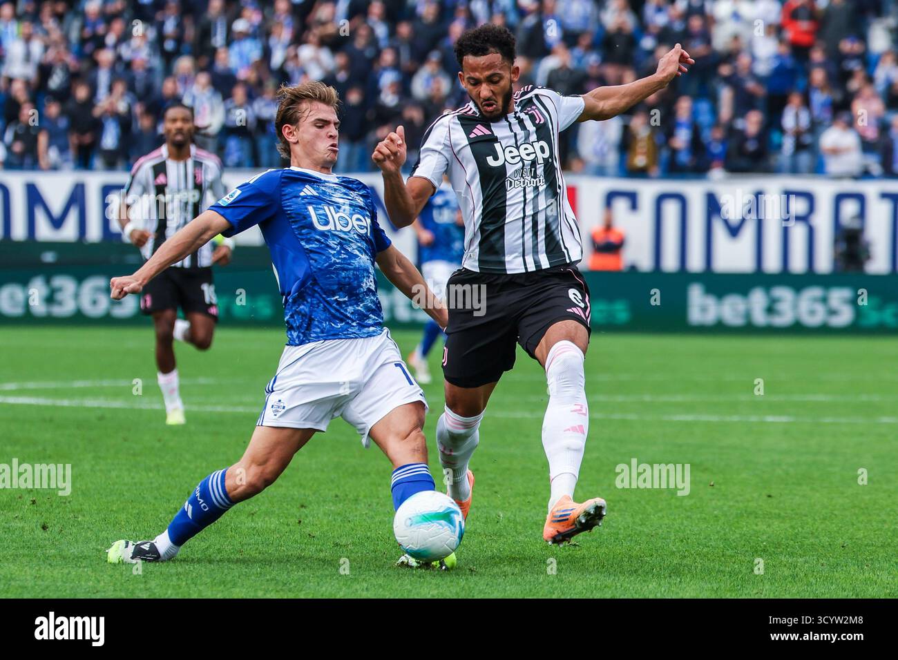 Nicolas Paz Martinez of Como 1907 competes for the ball with Lloyd ...