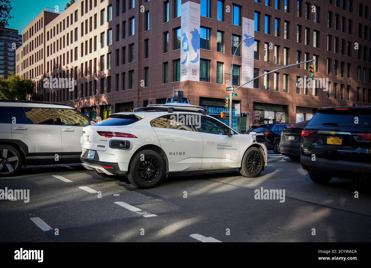 A Waymo self-driving car, possibly moving in autonomous mode, is stuck ...