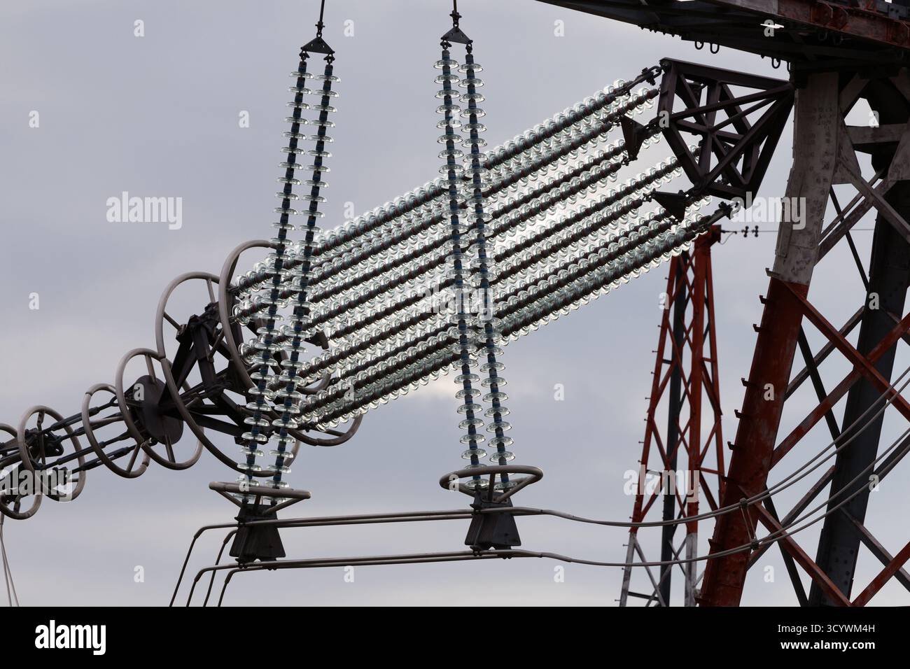 Glass insulators support high-voltage transmission lines carrying ...