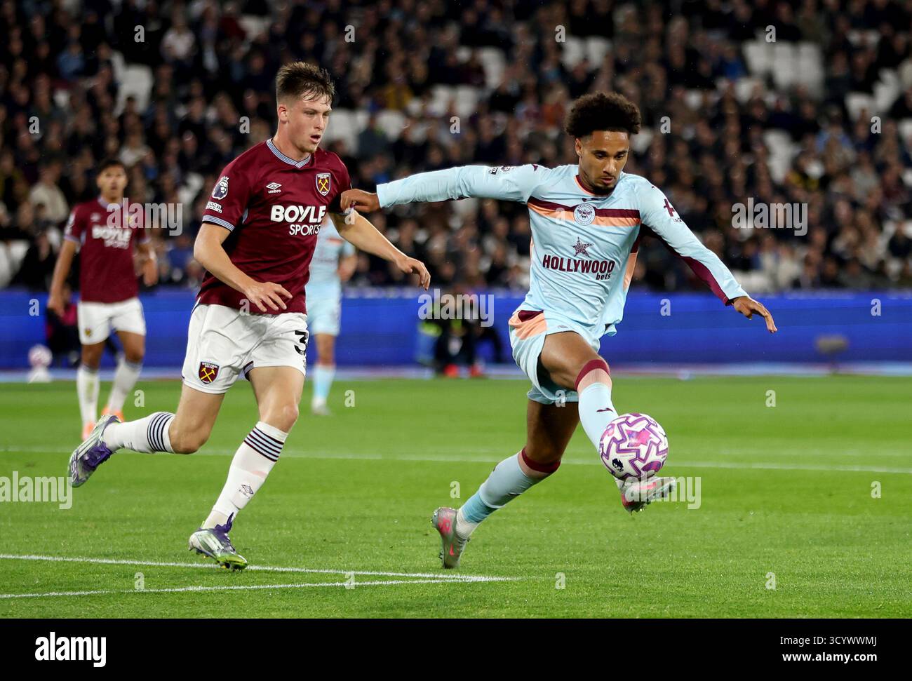 West Ham United's Oliver Scarles (left) and Brentford's Kevin Schade in ...