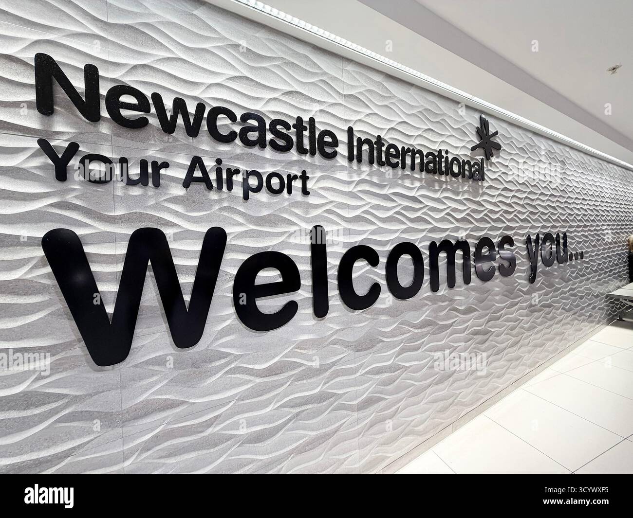 Wall sign with raised letters at Newcastle International Airport ...