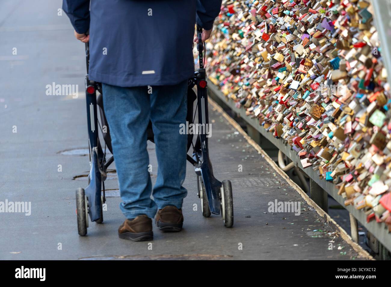 a man with rollators walk across the Hohenzollern Bridge, Cologne ...