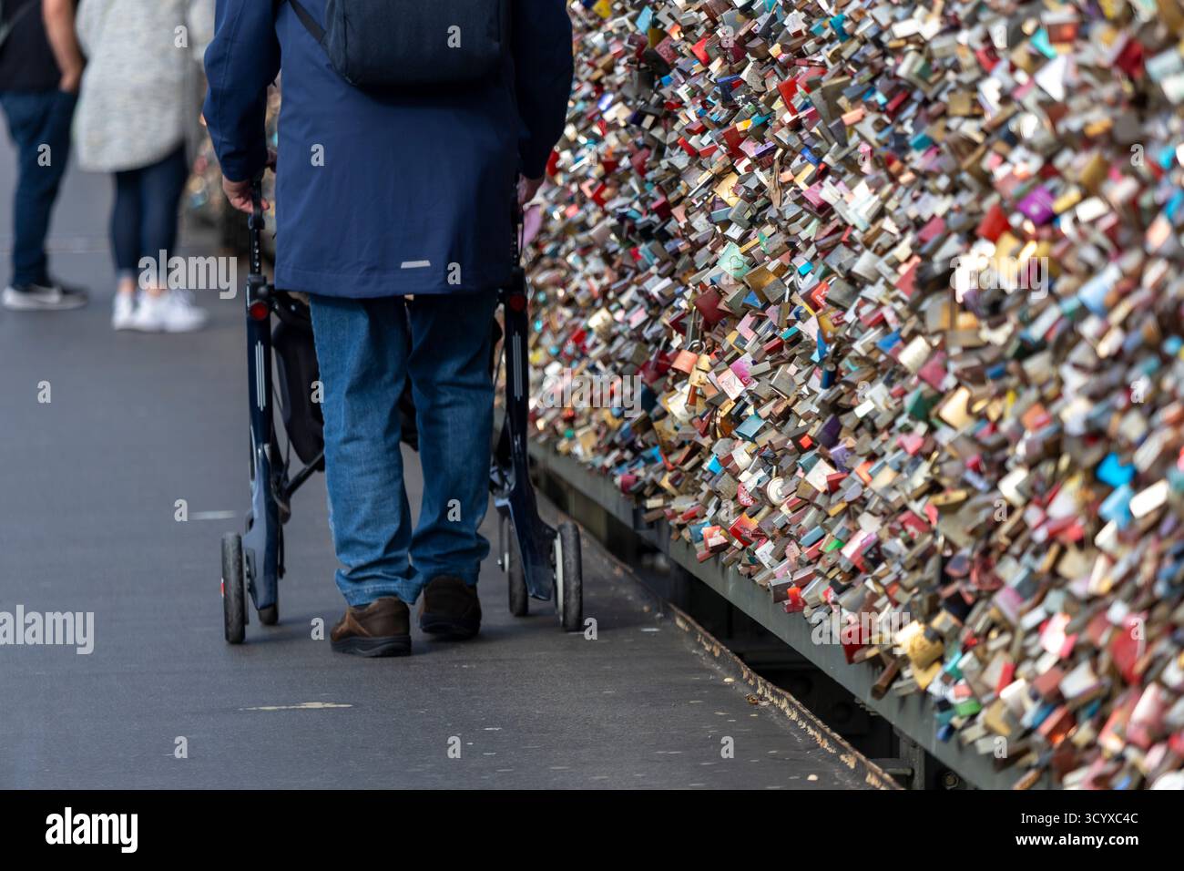 a man with rollators walk across the Hohenzollern Bridge, Cologne ...