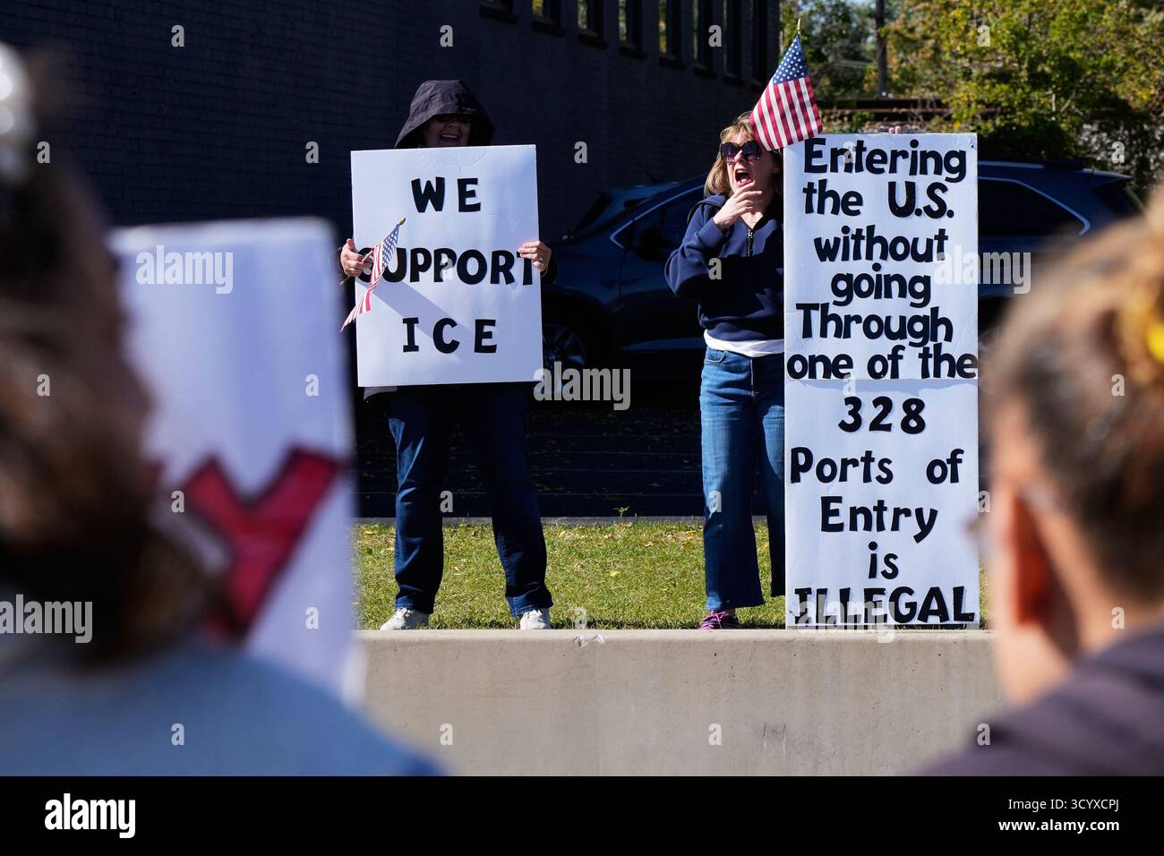 People hold signs and flags in support of support ICE outside an ICE ...