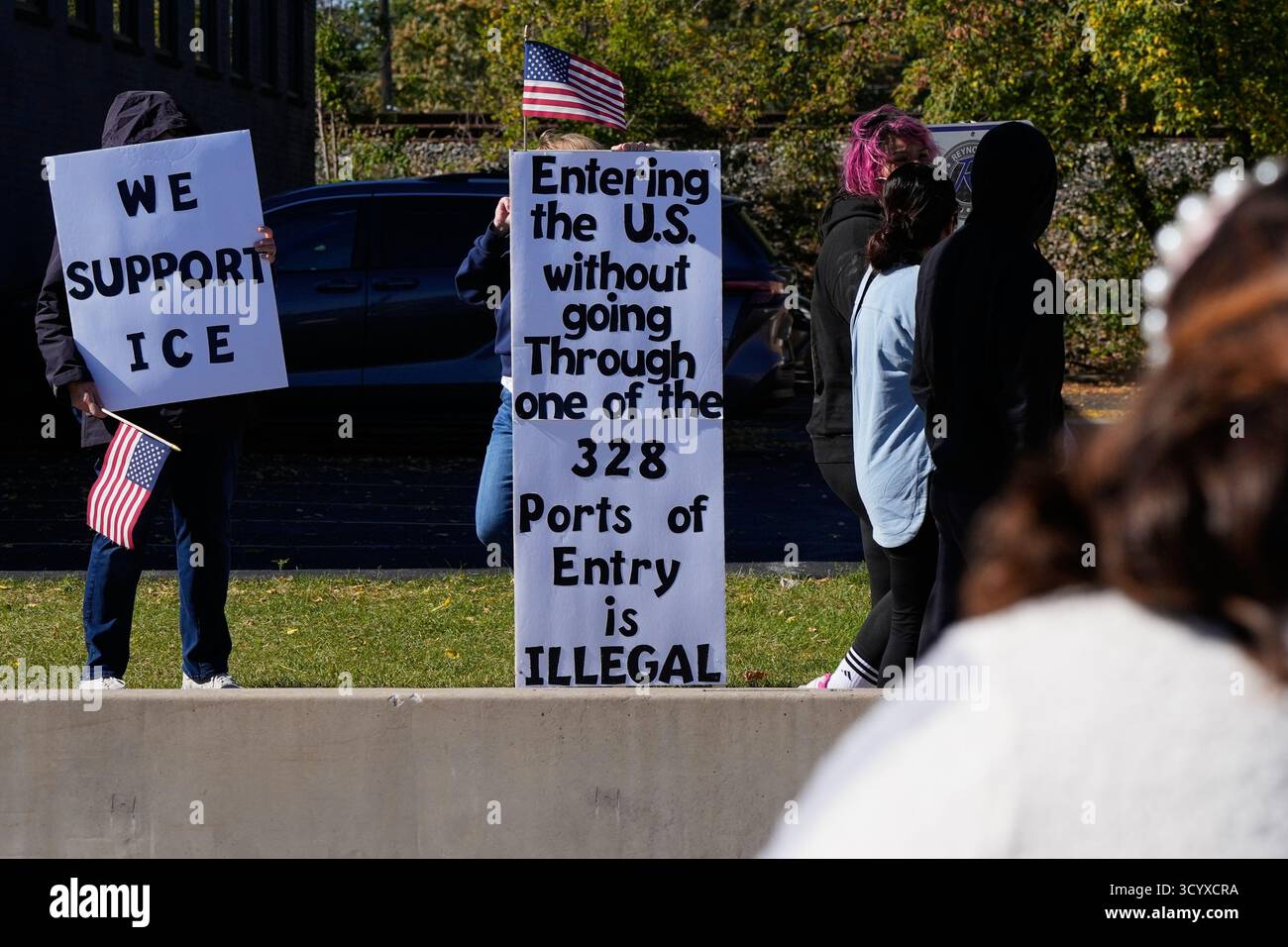 People hold signs and flags in support of support ICE outside an ICE ...
