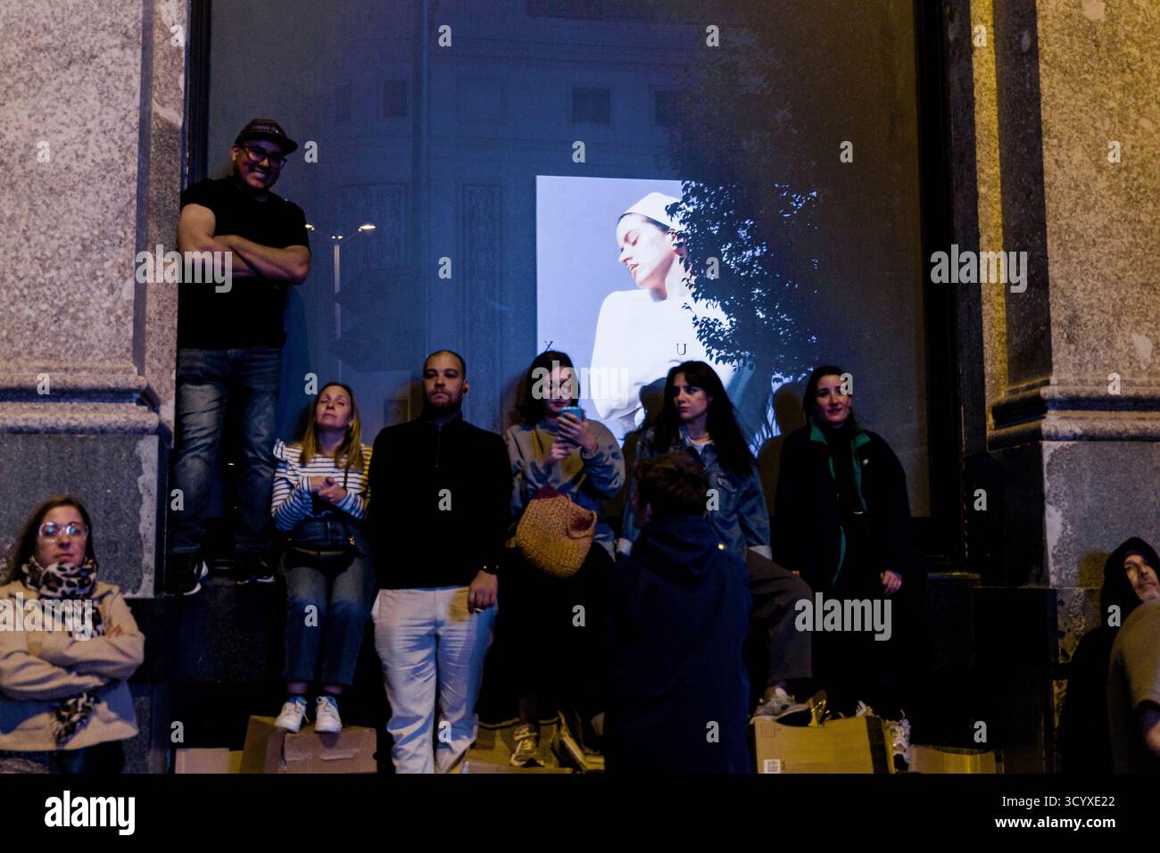 Several people look at the cover of Rosalia's new album, 'Lux', at the ...