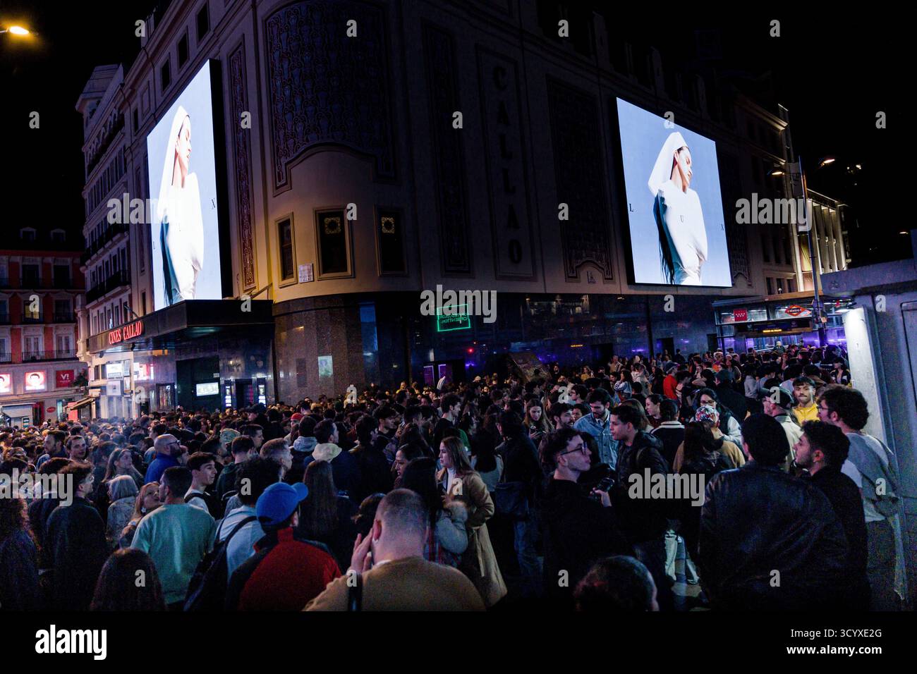 Dozens of people look at the cover of Rosalia's new album, 'Lux', at ...