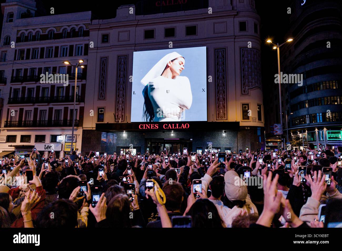 Dozens of people look at the cover of Rosalia's new album, 'Lux', at ...