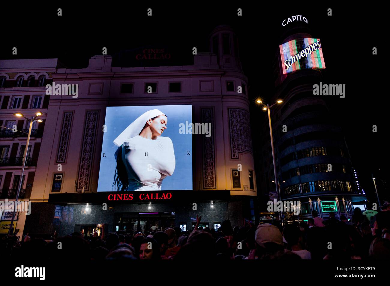 Dozens of people look at the cover of Rosalia's new album, 'Lux', at ...