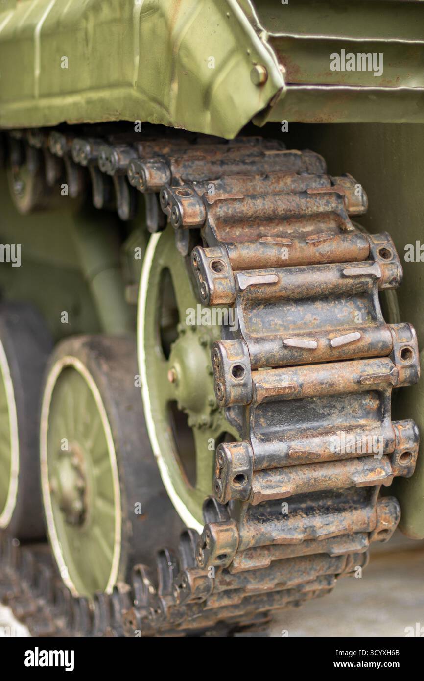 Rusty tank wheel and tracks. Detailed shot of a rusted tank wheel with ...