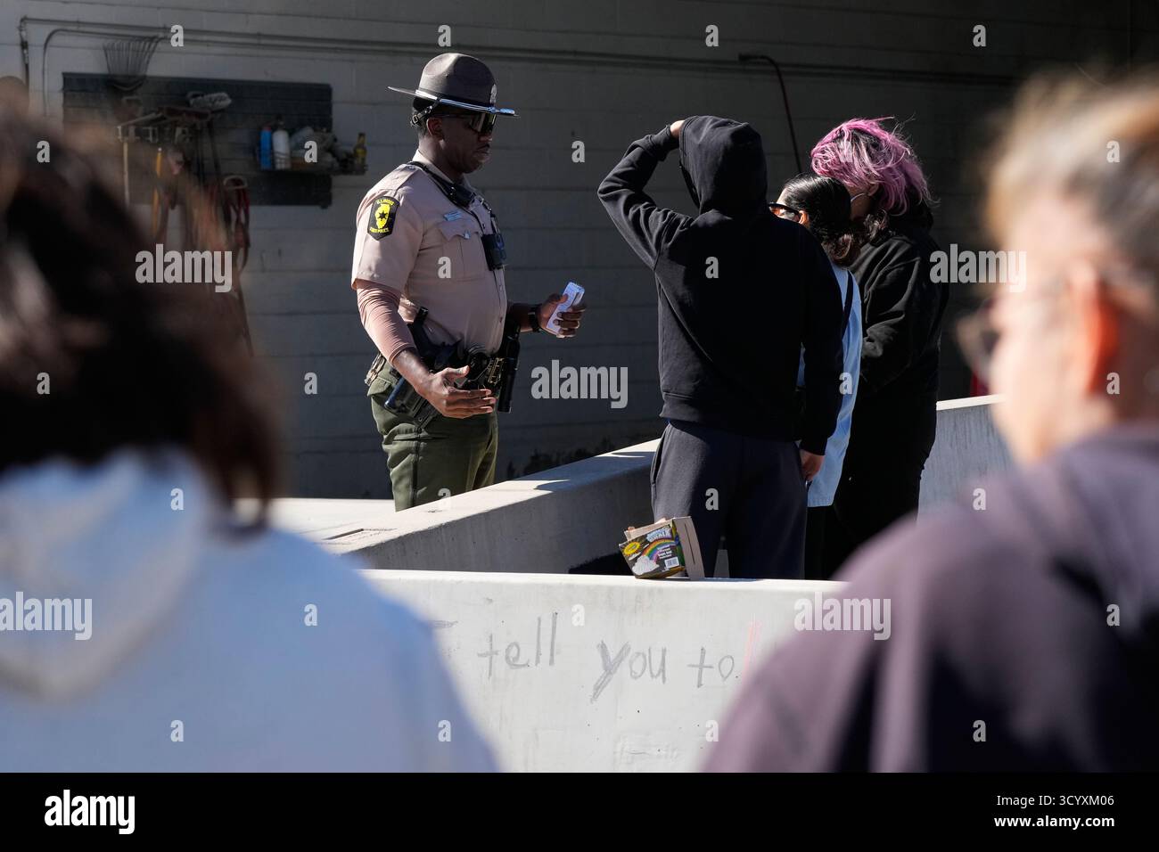 A Illinois State police officer talks to family members whose uncle was ...