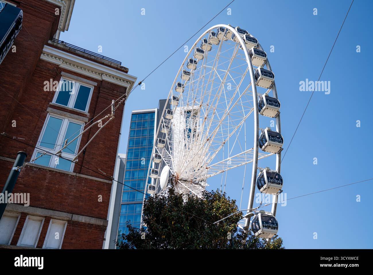 The SkyView Atlanta Ferris wheel rises beside historic brick buildings ...