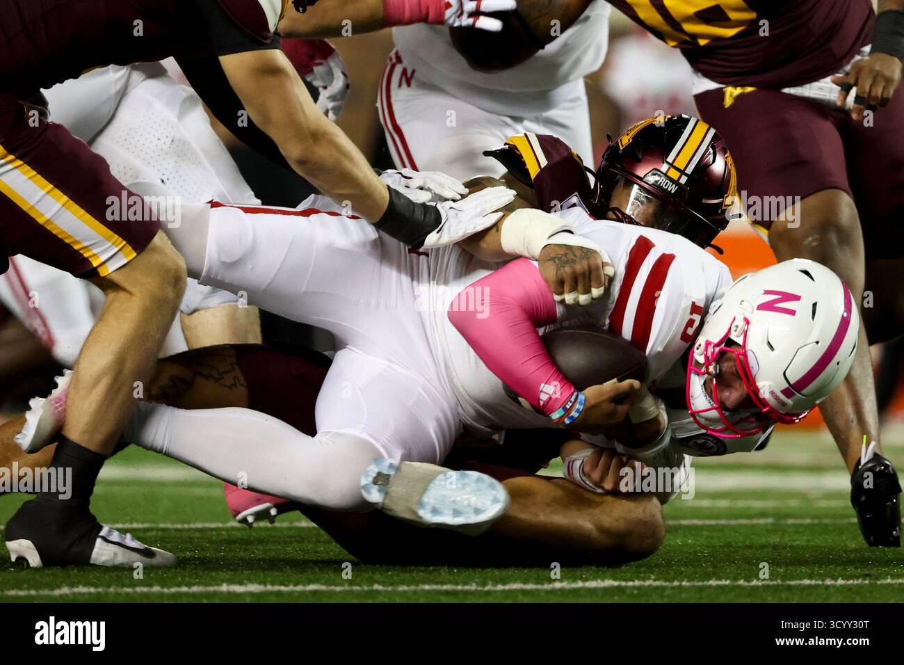 Minnesota defensive lineman Anthony Smith, behind, sacks Nebraska ...
