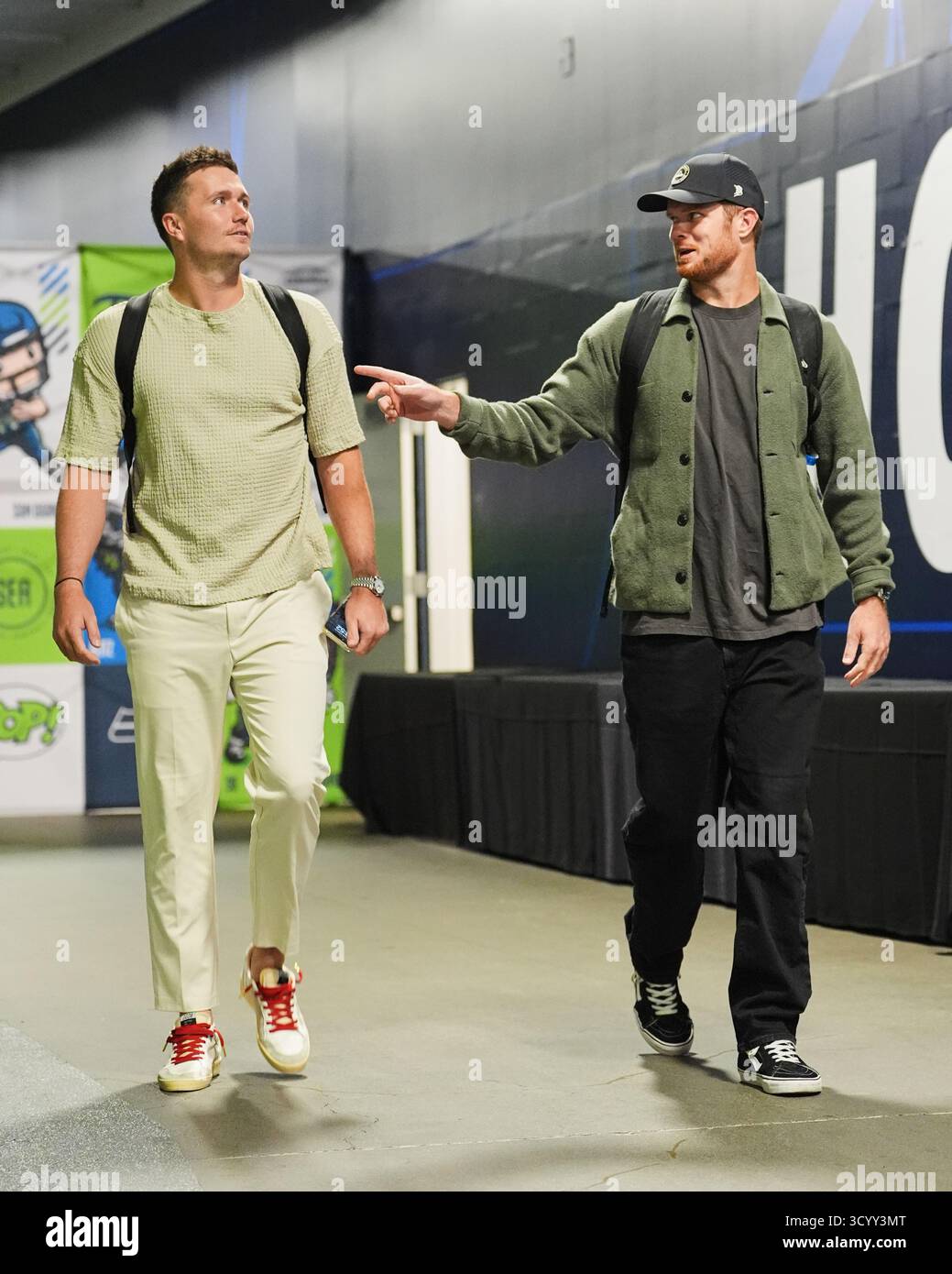 Seattle Seahawks' Drew Lock, left, and Sam Darnold, right, arrive for ...