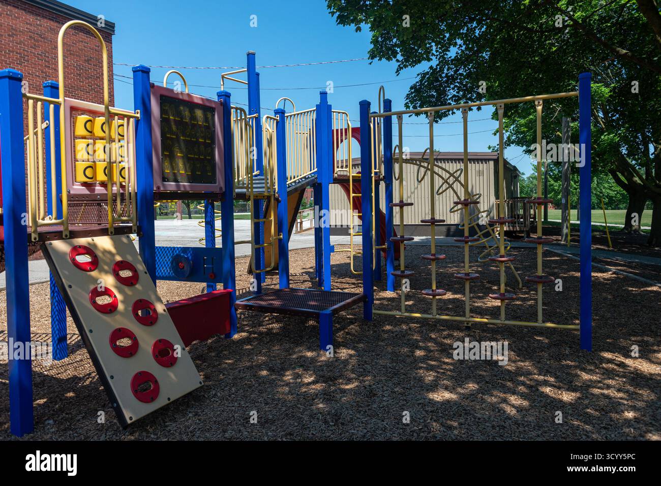 a sunny day scene of a colorful playground with slides, ladders, and ...