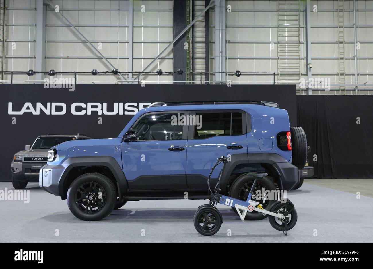 A photo shows TOYOTA's new vehicles, "Land Cruiser FJ" (back) and "LAND ...