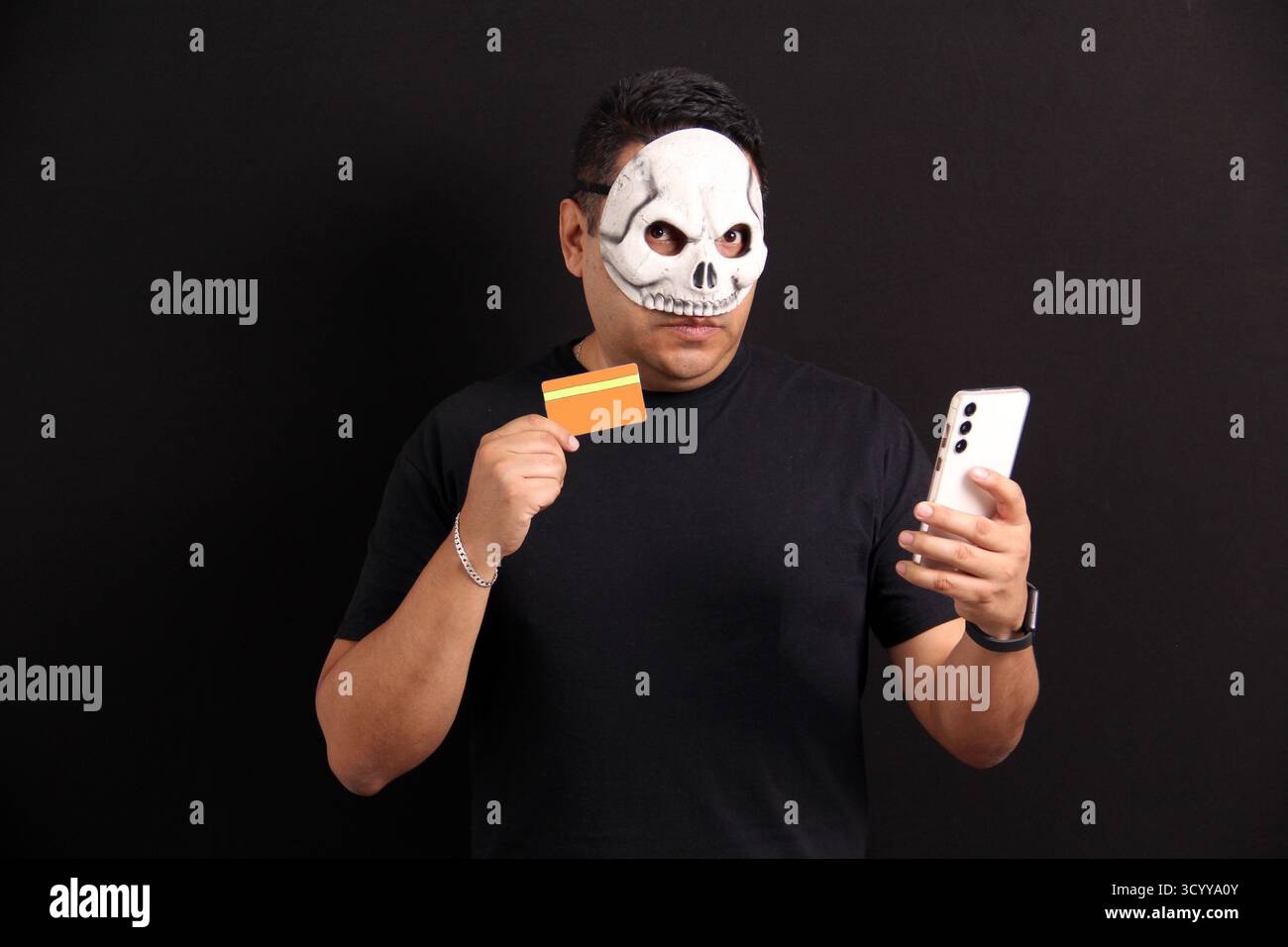 Mexican man wearing a Catrin Calavera mask uses his cell phone and ...