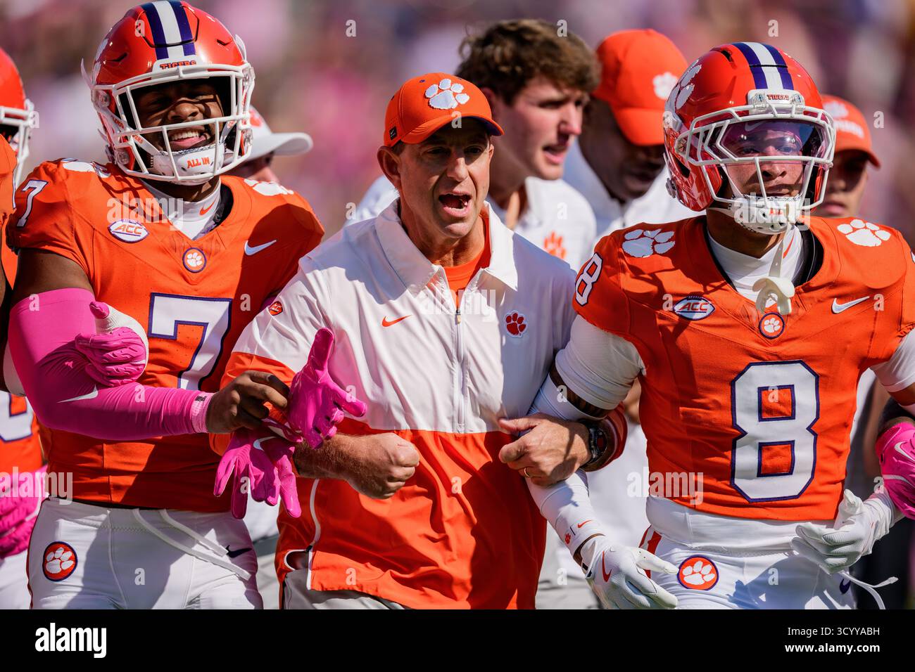 Clemson head coach Dabo Swinney walks with his players before an NCAA ...