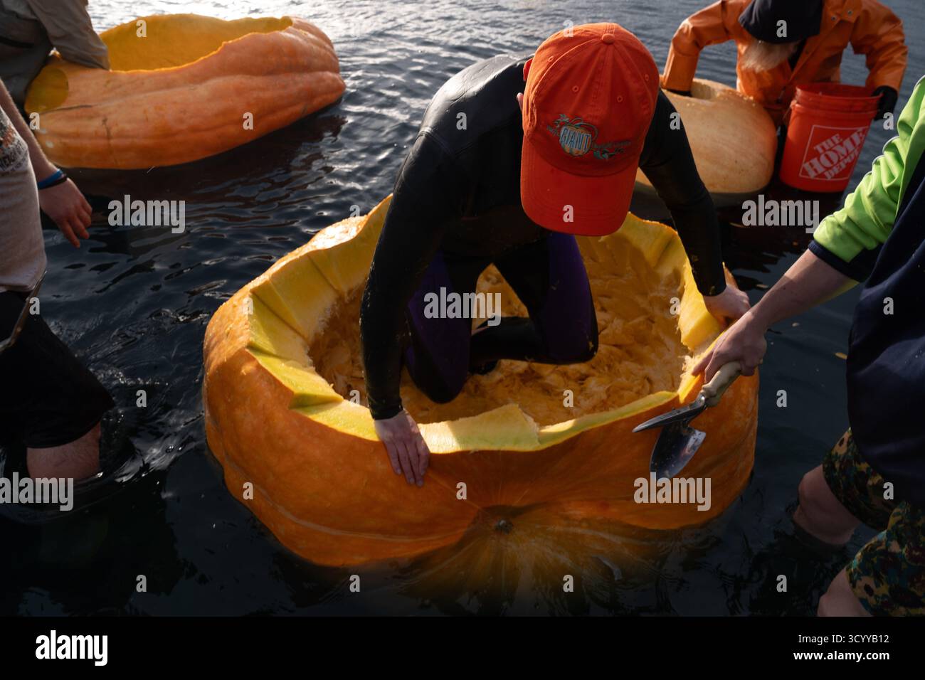 Tiberius Palmer climbs into a giant pumpkin to test the buoyancy before ...
