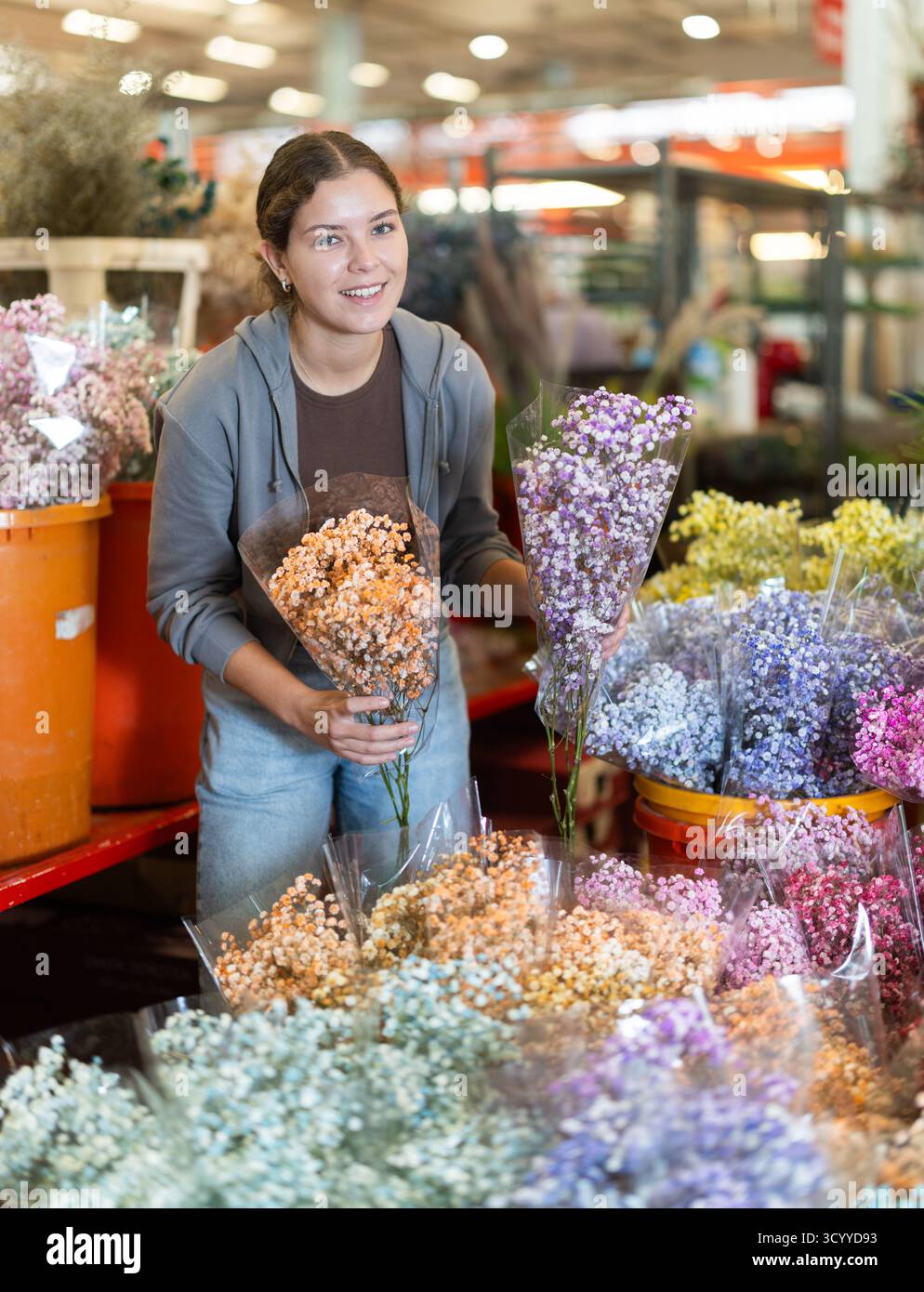 Female customer chooses a bouquet of Gypsophila in flower shop Stock ...