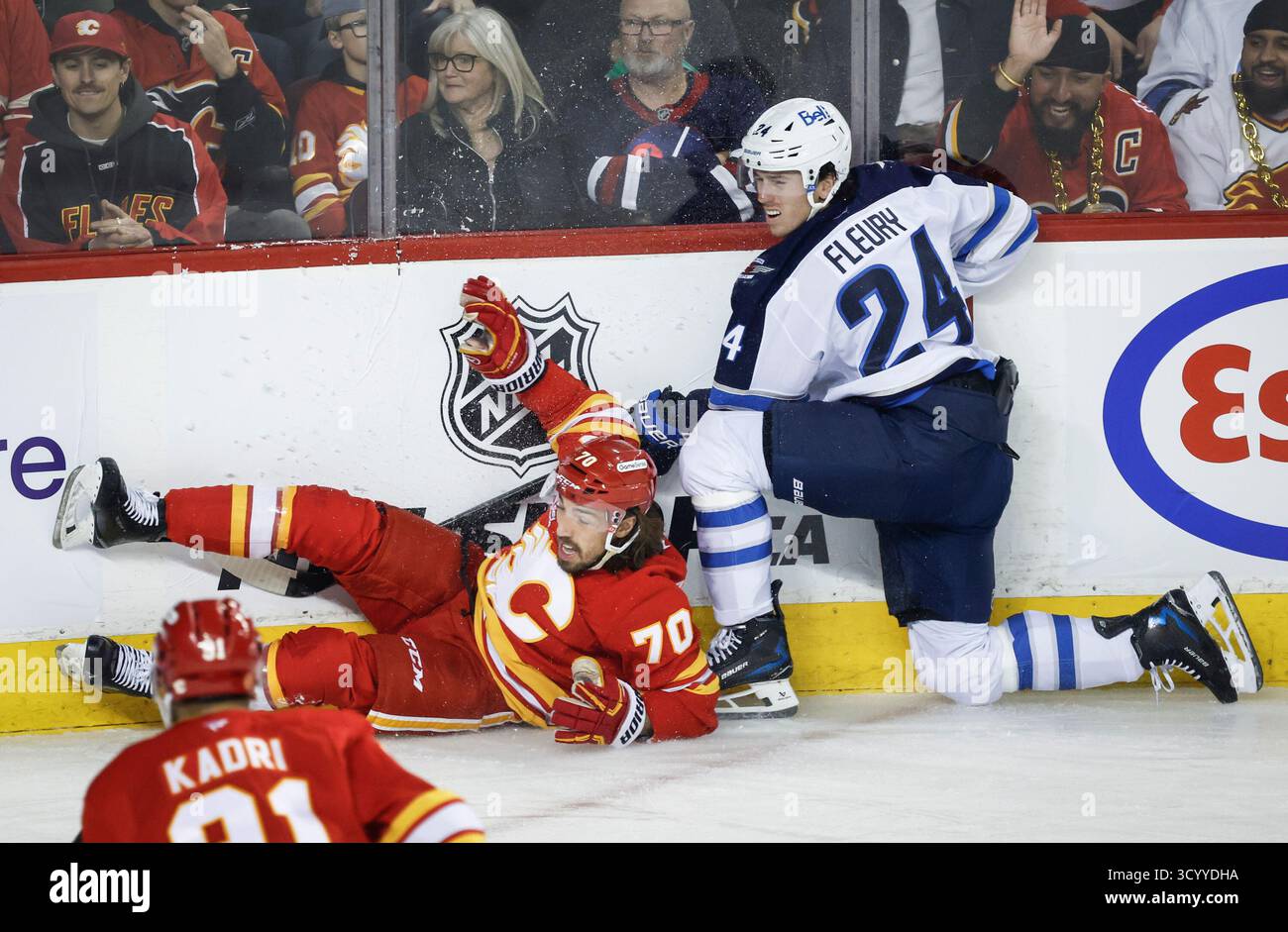 Winnipeg Jets' Haydn Fleury, right, is checked by Calgary Flames' Ryan ...