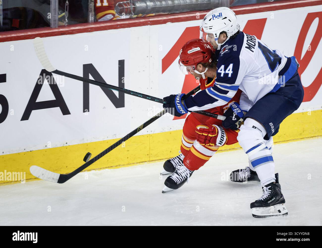 Winnipeg Jets' Josh Morrissey (44) checks Calgary Flames' Blake Coleman ...