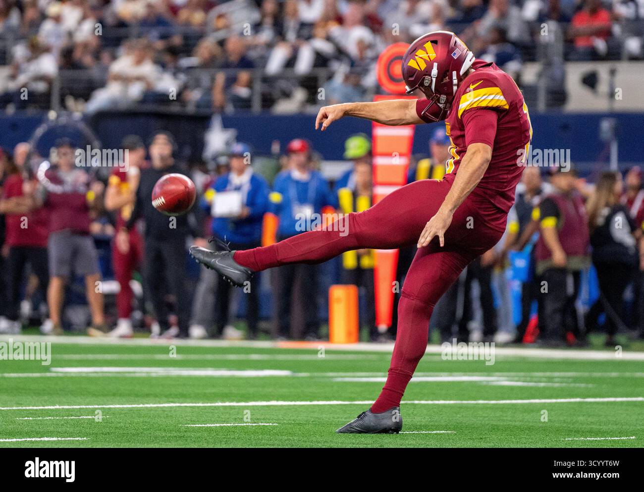 Washington Commanders punter Tress Way punts the ball during a football ...