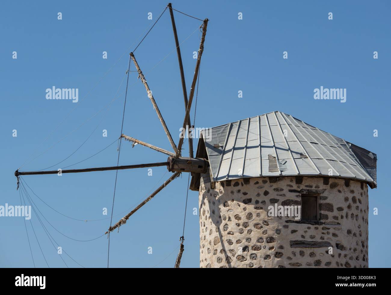 Architecture Details View of an ancient Greek mill and palm trees on ...