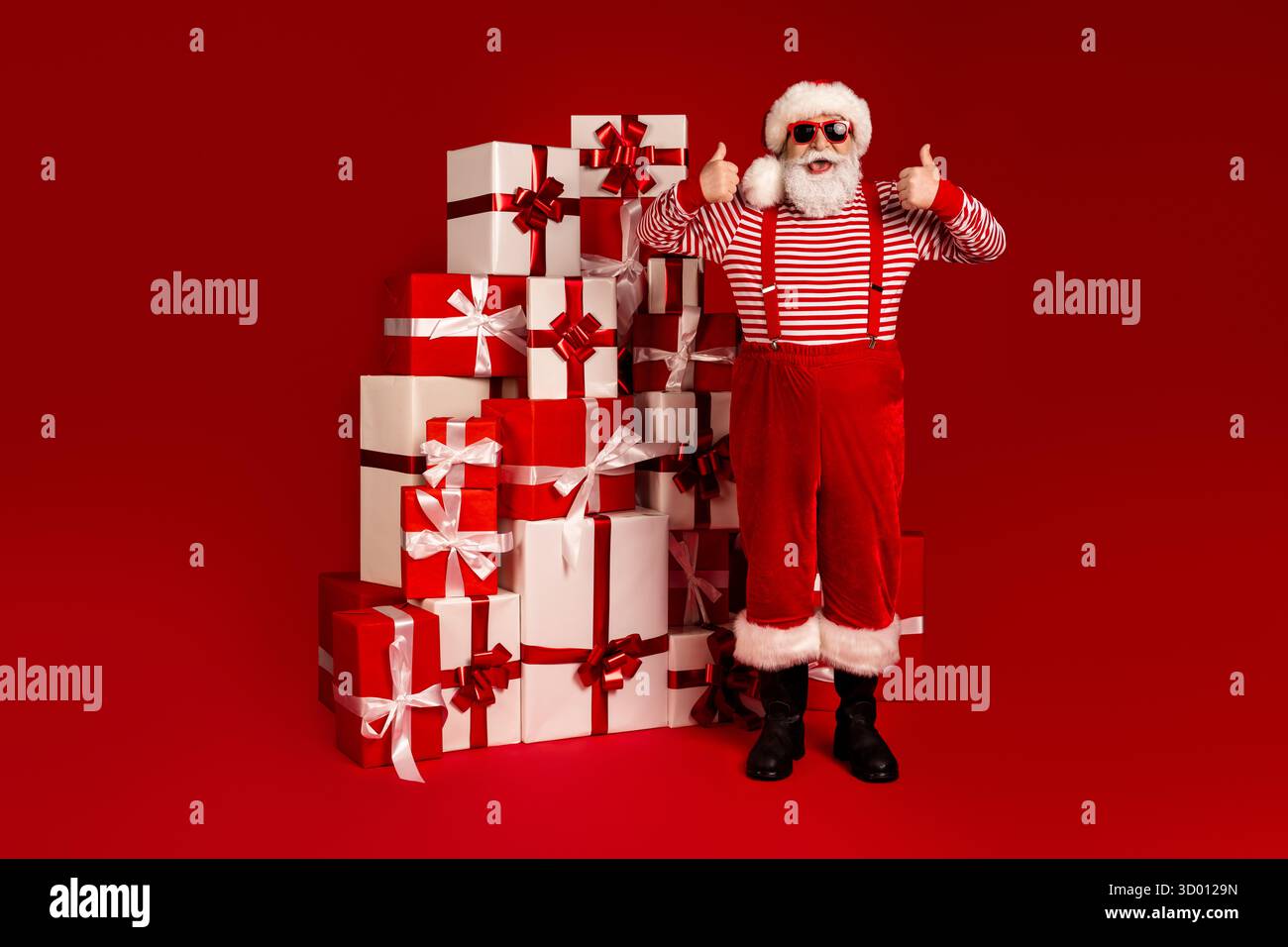Festive santa character with red white striped outfit and stacked gifts ...