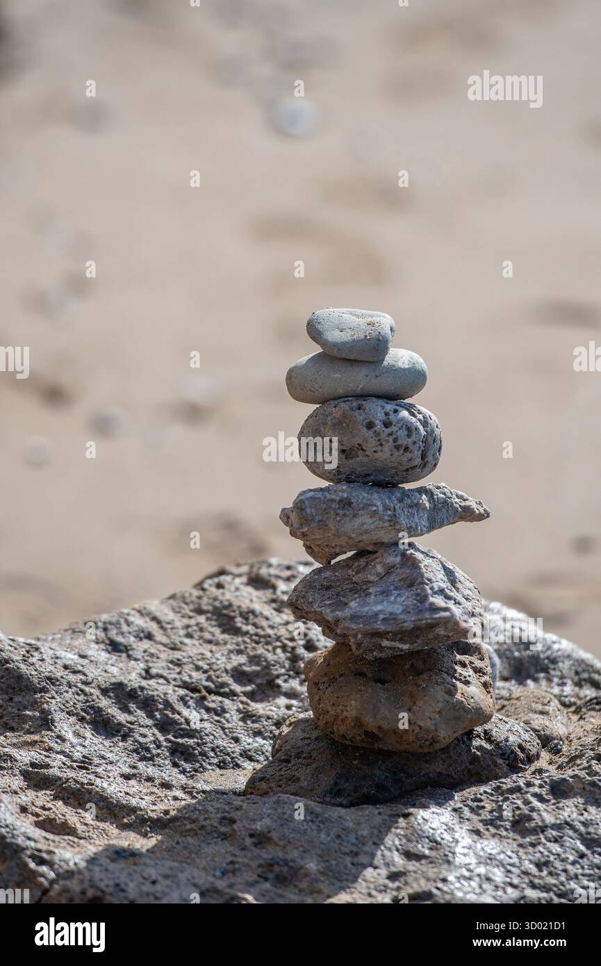 rock stack, balancing rocks, rock tower, on a beach, sandy, piled rocks ...