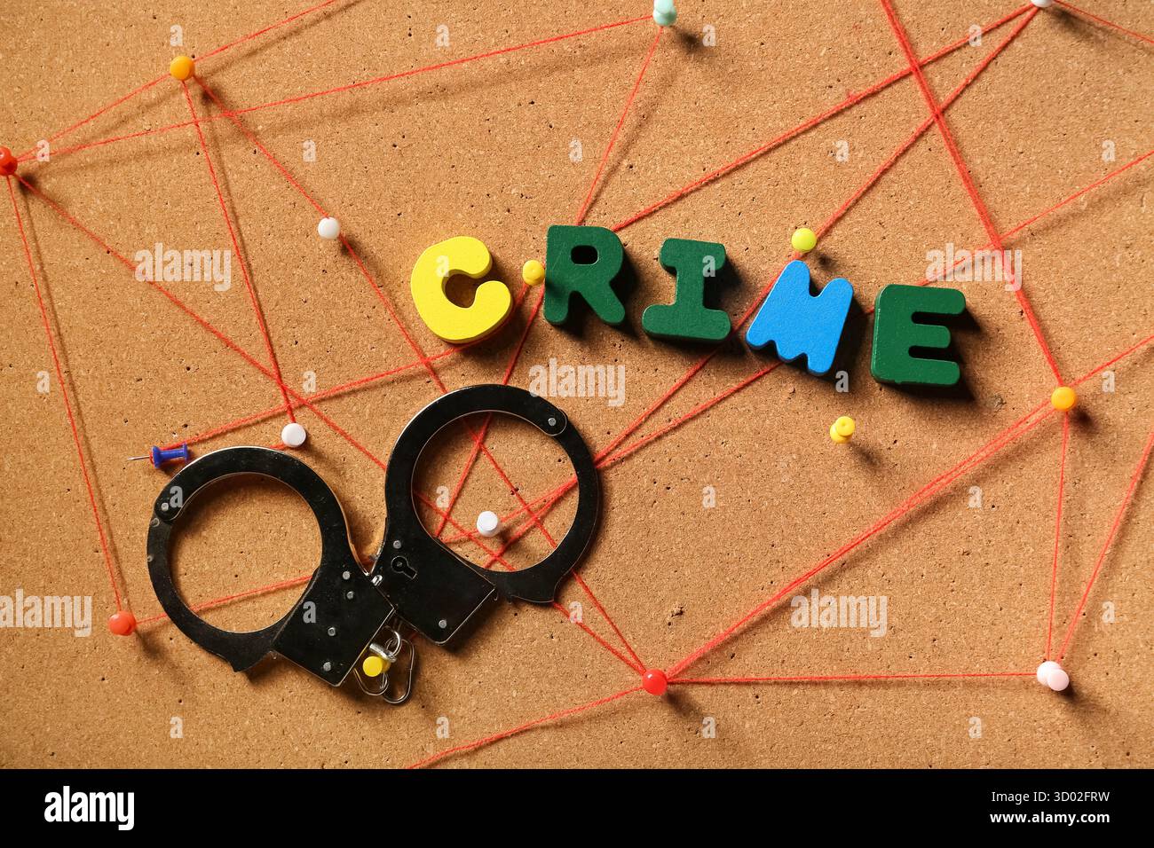 Word CRIME with handcuffs, pins and thread on board Stock Photo - Alamy
