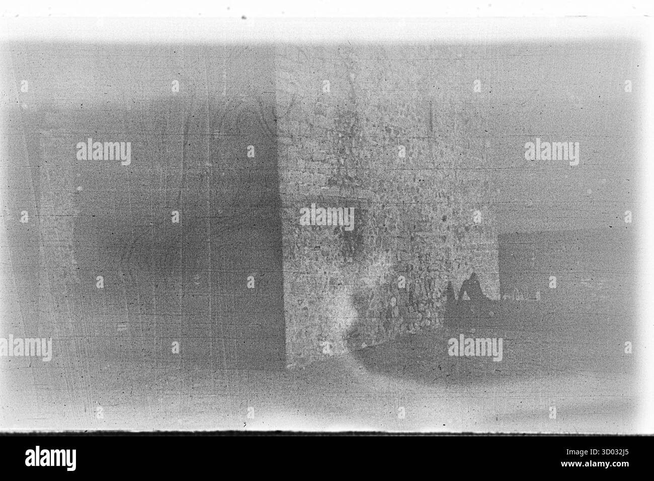 Abstract black and white photograph showing a rough, weathered surface ...