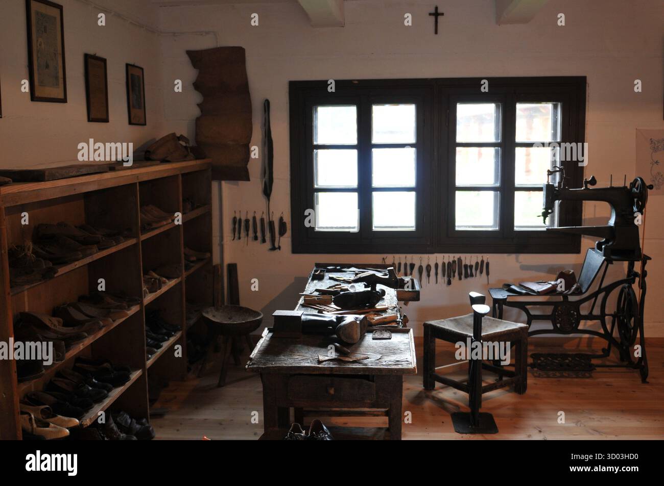 Traditional shoemaker’s workshop with vintage tools and shoes at the ...