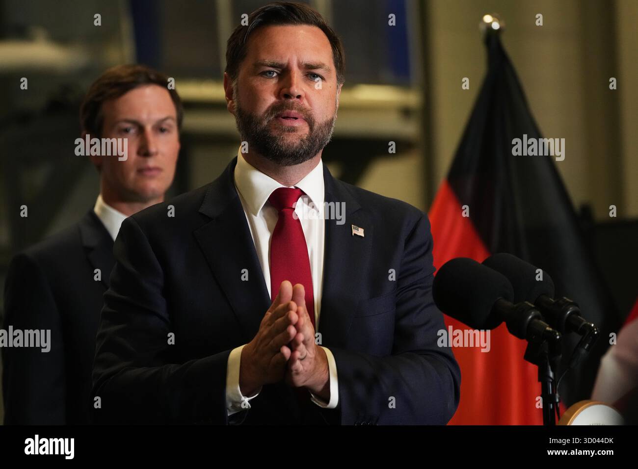 U.S. Vice President JD Vance speak to the media as Jared Kushner looks ...