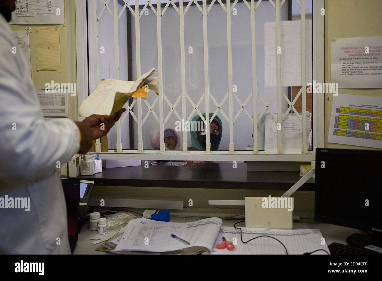 FILE - A woman waits for medication inside a pharmacy in a clinic in Ha ...