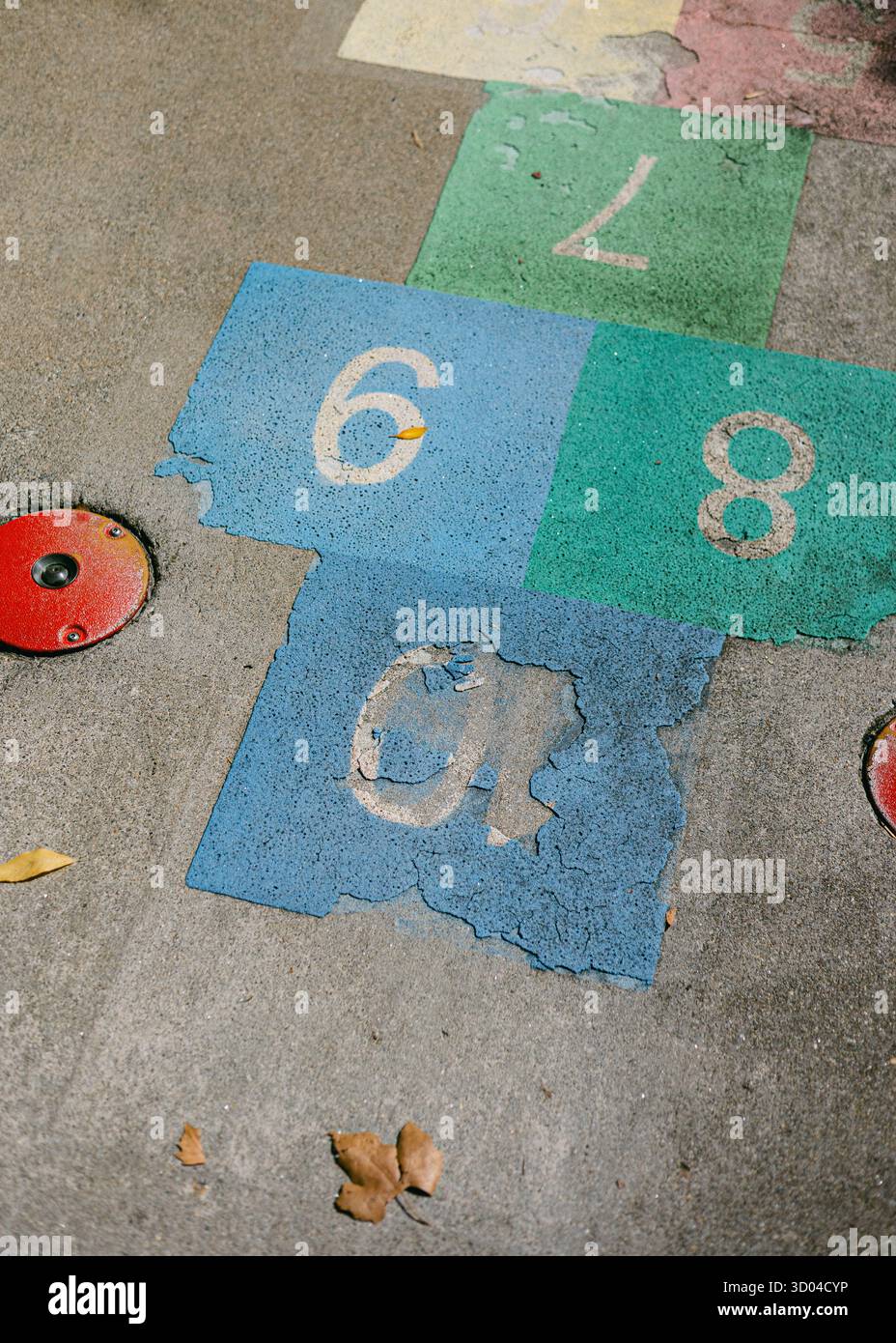 Colorful hopscotch pattern on a playground surface with leaves ...