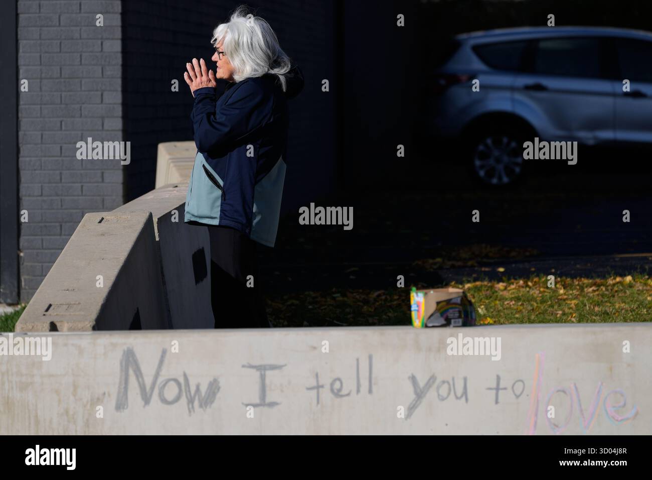 Susan Rohde prays outside an ICE processing facility for those who are ...