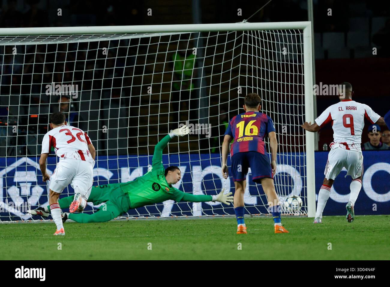 Olympiacos' Ayoub El Kaabi, right, scores a penalty, his side's first ...