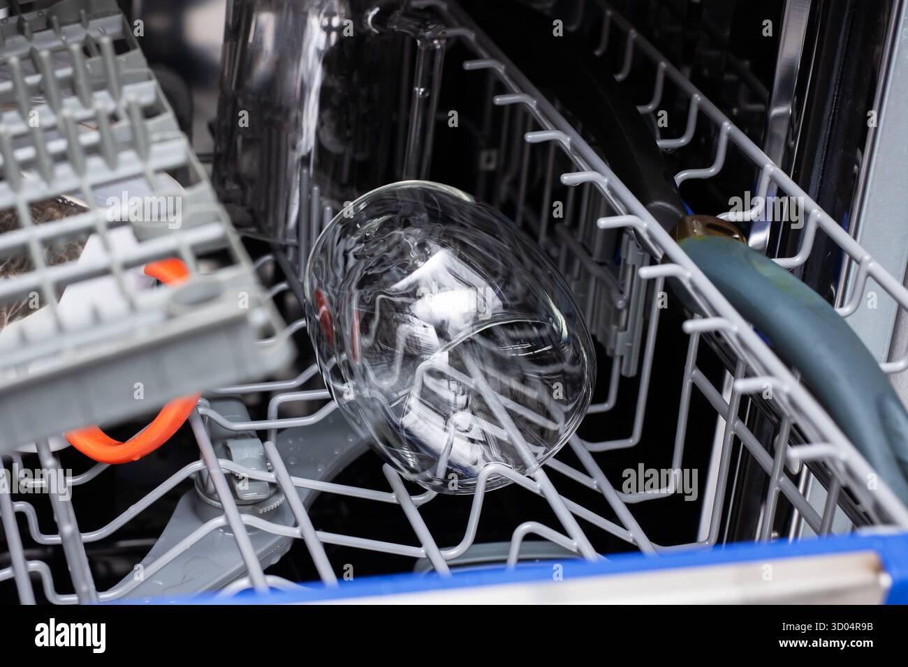 An organized dishwasher loaded with a glass. Perfect for showcasing ...