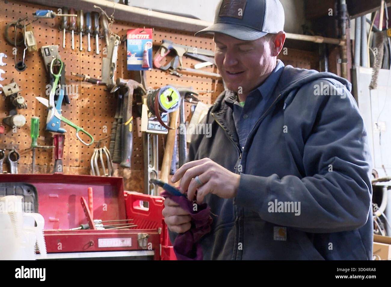 FILE - Bryant Kagay holds a tool in the workshop of the farm he co-owns ...