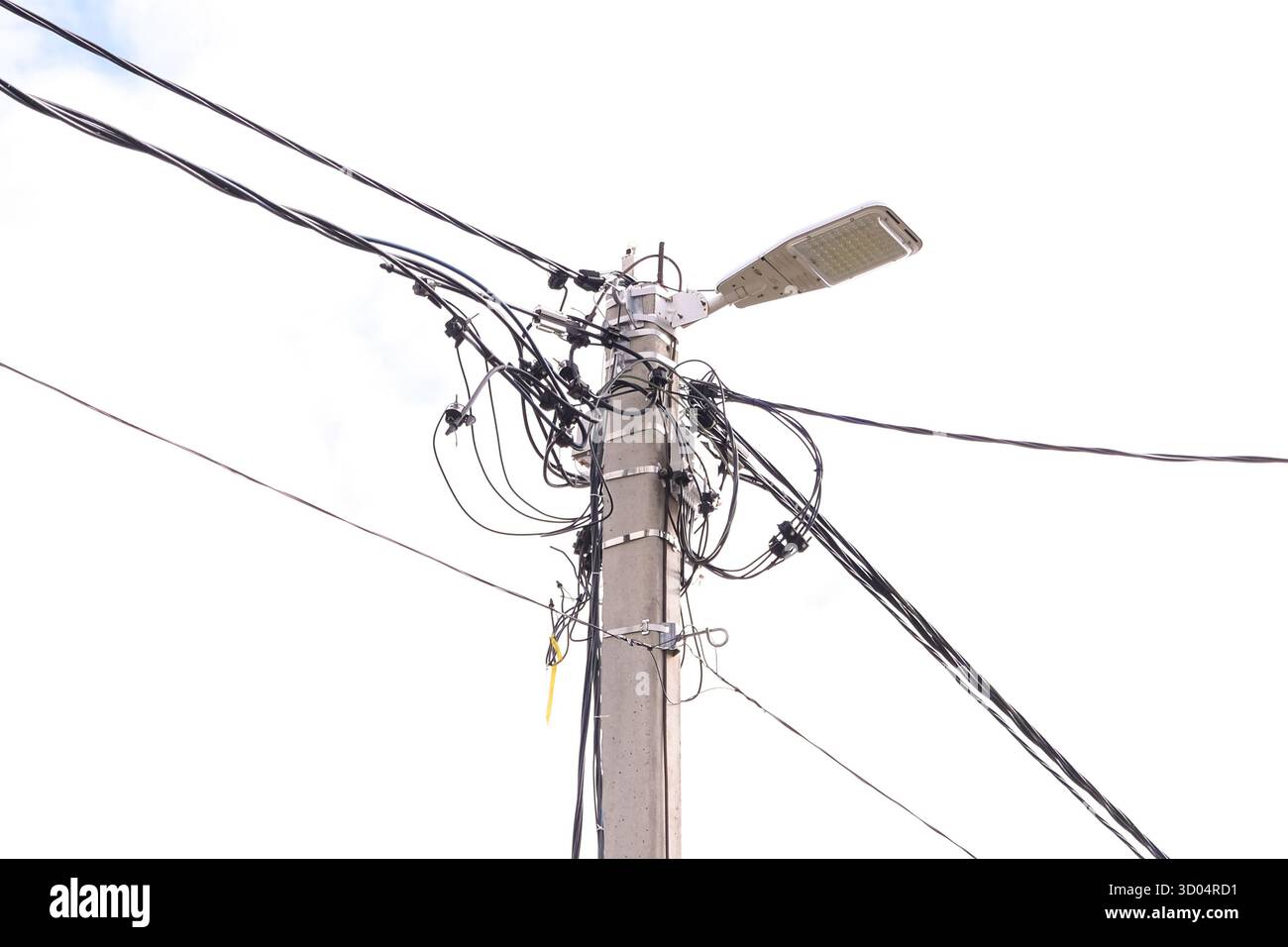 Russia, Saint Petersburg, 23.08.2025 Concrete power pole with messy ...